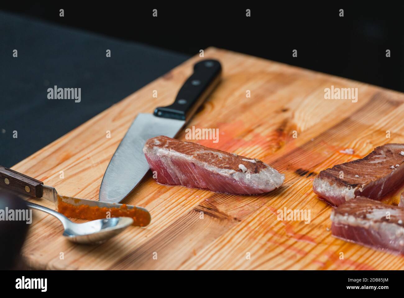 lightly greased tuna fish on wooden plank Stock Photo - Alamy