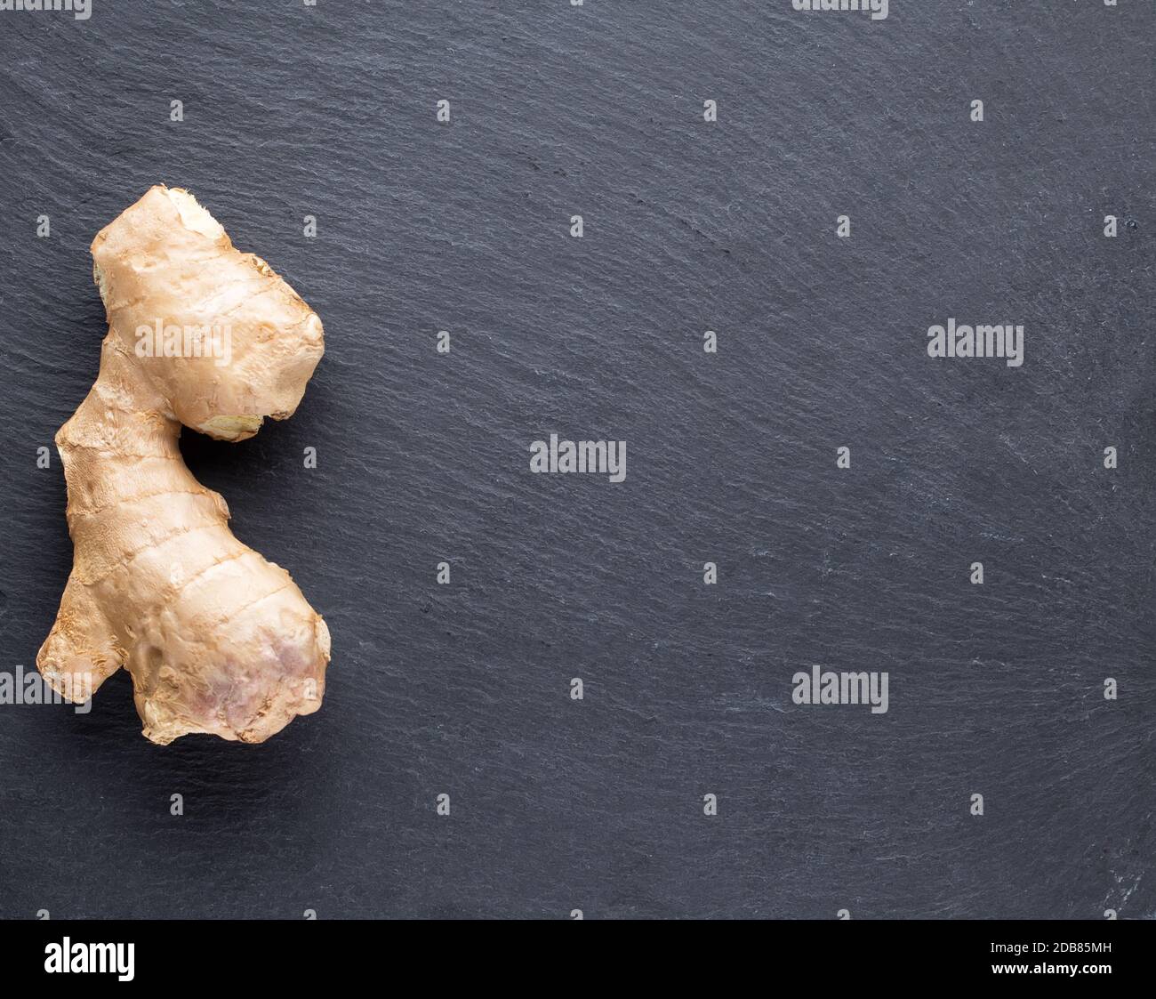 Ginger root shot from above on a slate board Stock Photo - Alamy