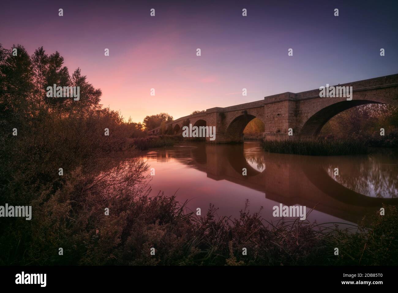 Amazing Landscape. Medieval Bridge over a tranquil river at beautiful ...