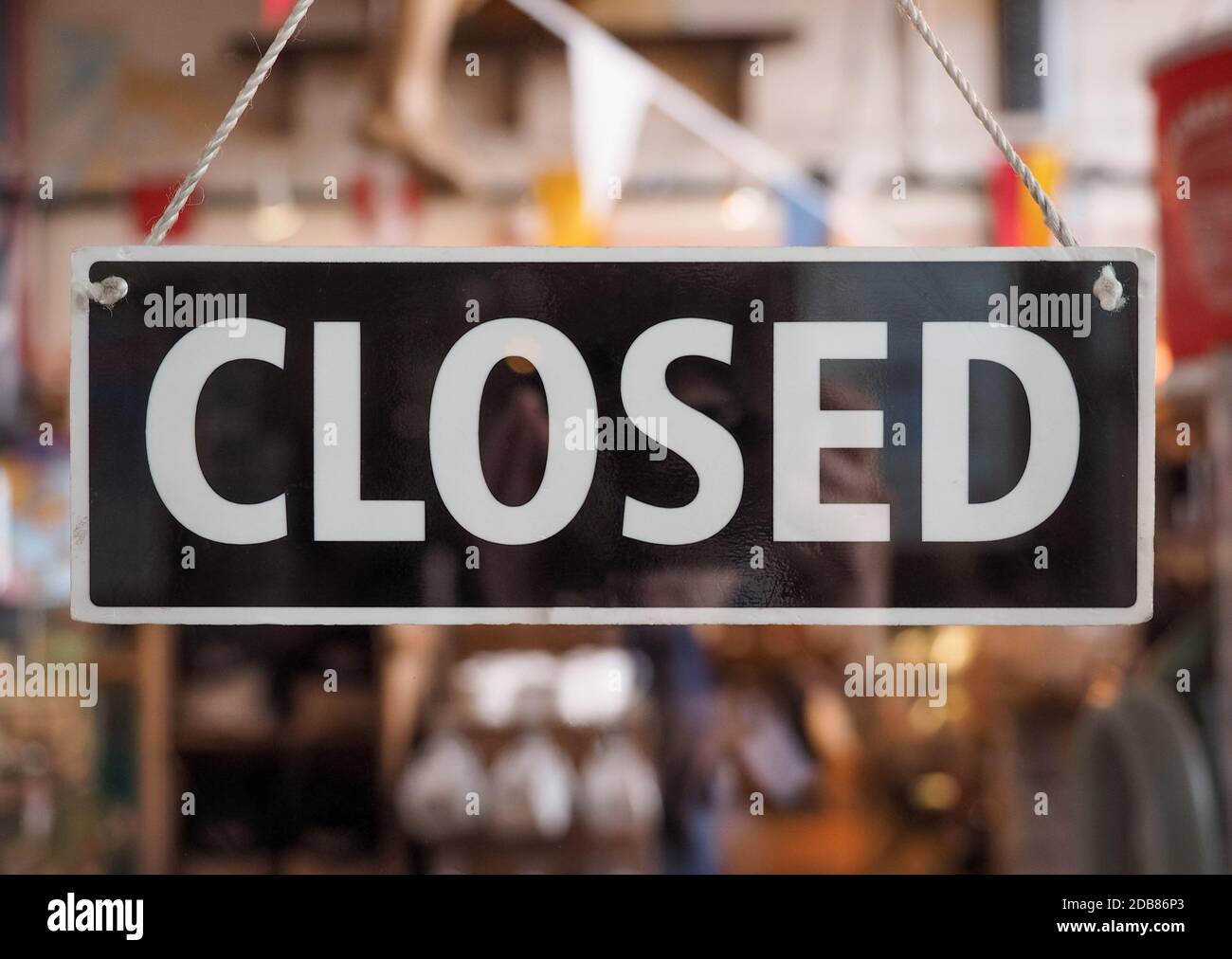 Closed sign in a shop window with reflections Stock Photo - Alamy