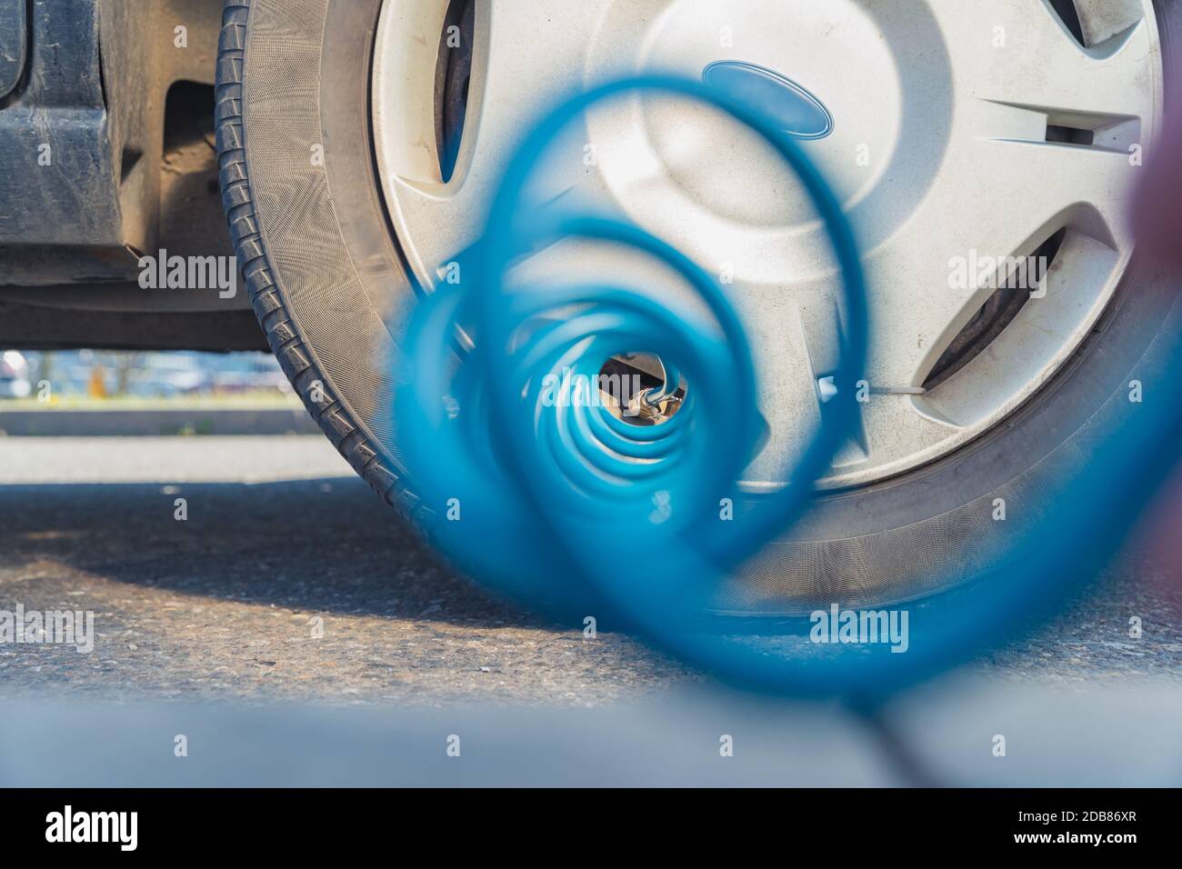 inflating the car tires with air using a compressor Stock Photo - Alamy