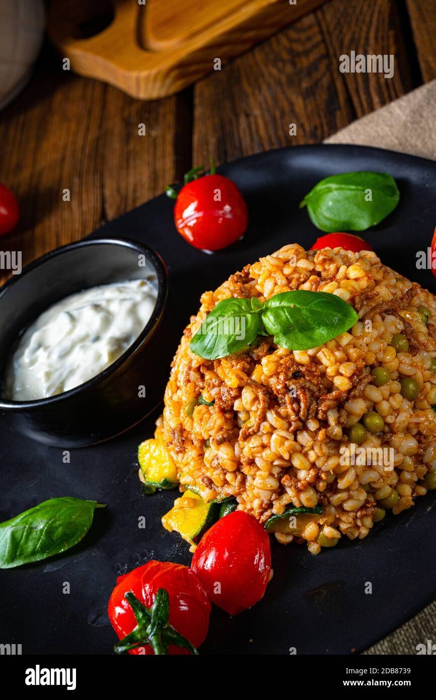 rustic bulgur fried with minced meat and vegetables Stock Photo - Alamy