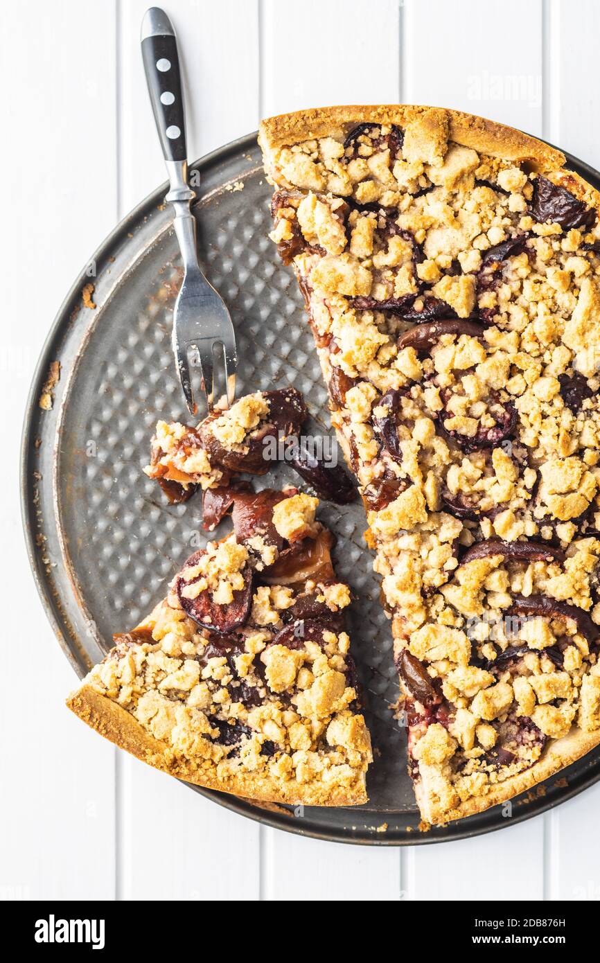 Sweet plum pie. Cut pie on plate. Top view Stock Photo - Alamy