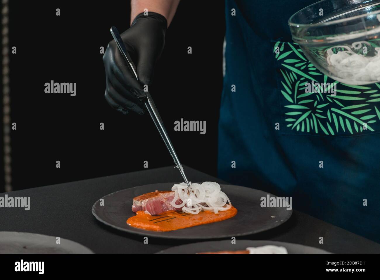 lightly greased tuna fish on a blck ceramic plate Stock Photo - Alamy