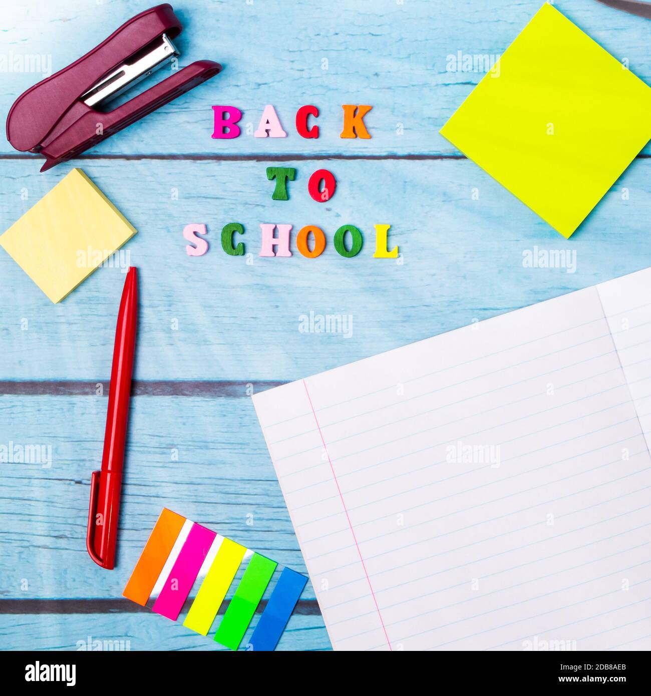 Layout of school supplies on a blue wooden background. Top view, sun ...