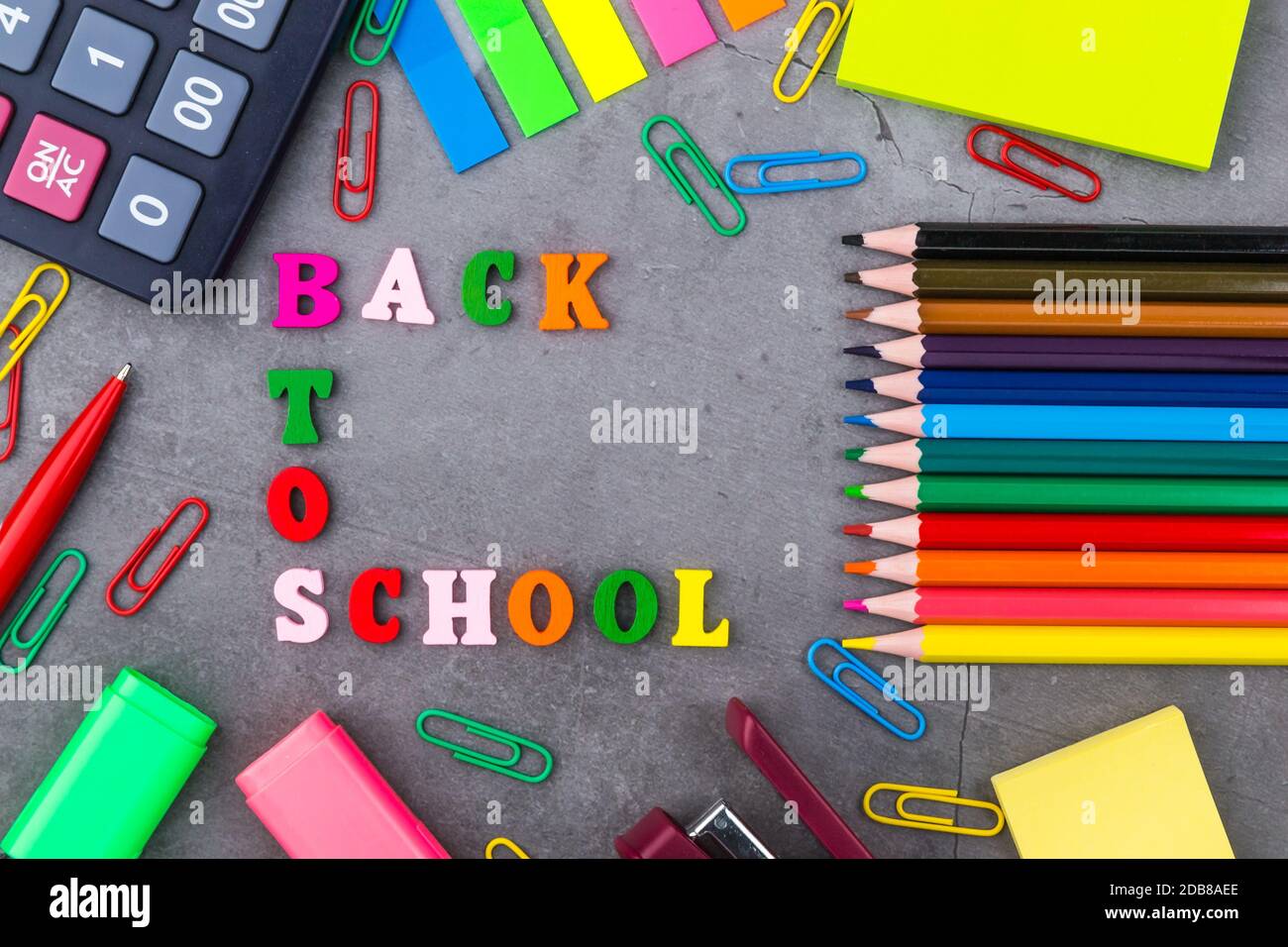 The layout of school supplies on a dark gray background. The view from ...