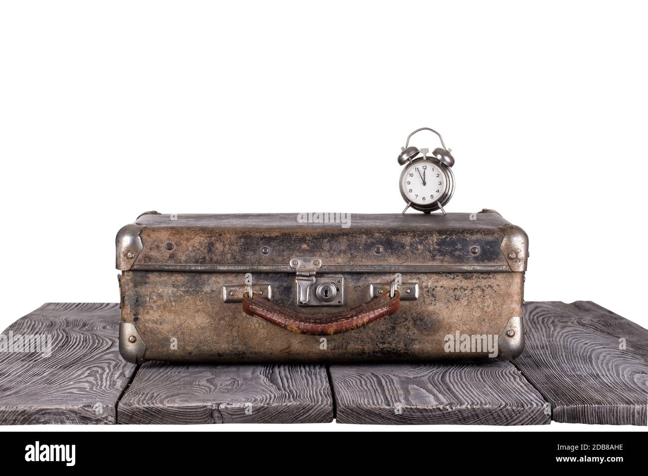 An old suitcase with an alarm clock on wooden boards. Isolated on white ...
