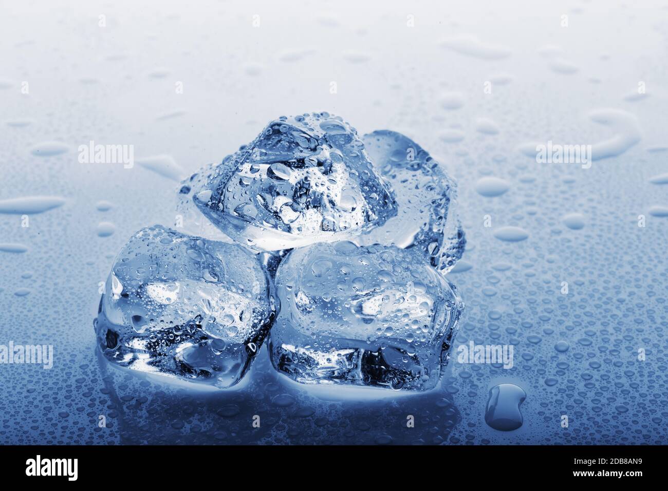 Frozen large ice cubes in droplets of water on a wet table Stock Photo ...