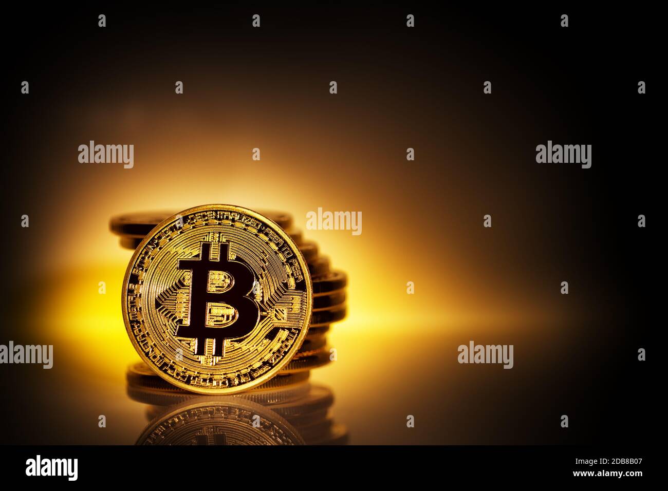 Gold bitcoin on yellow background with pile of coins. The concept of ...