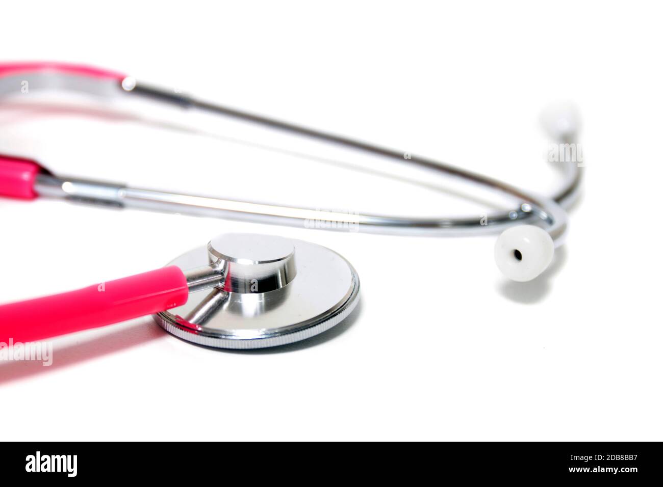 Close up view of a pink doctor's stethoscope isolated on a white ...