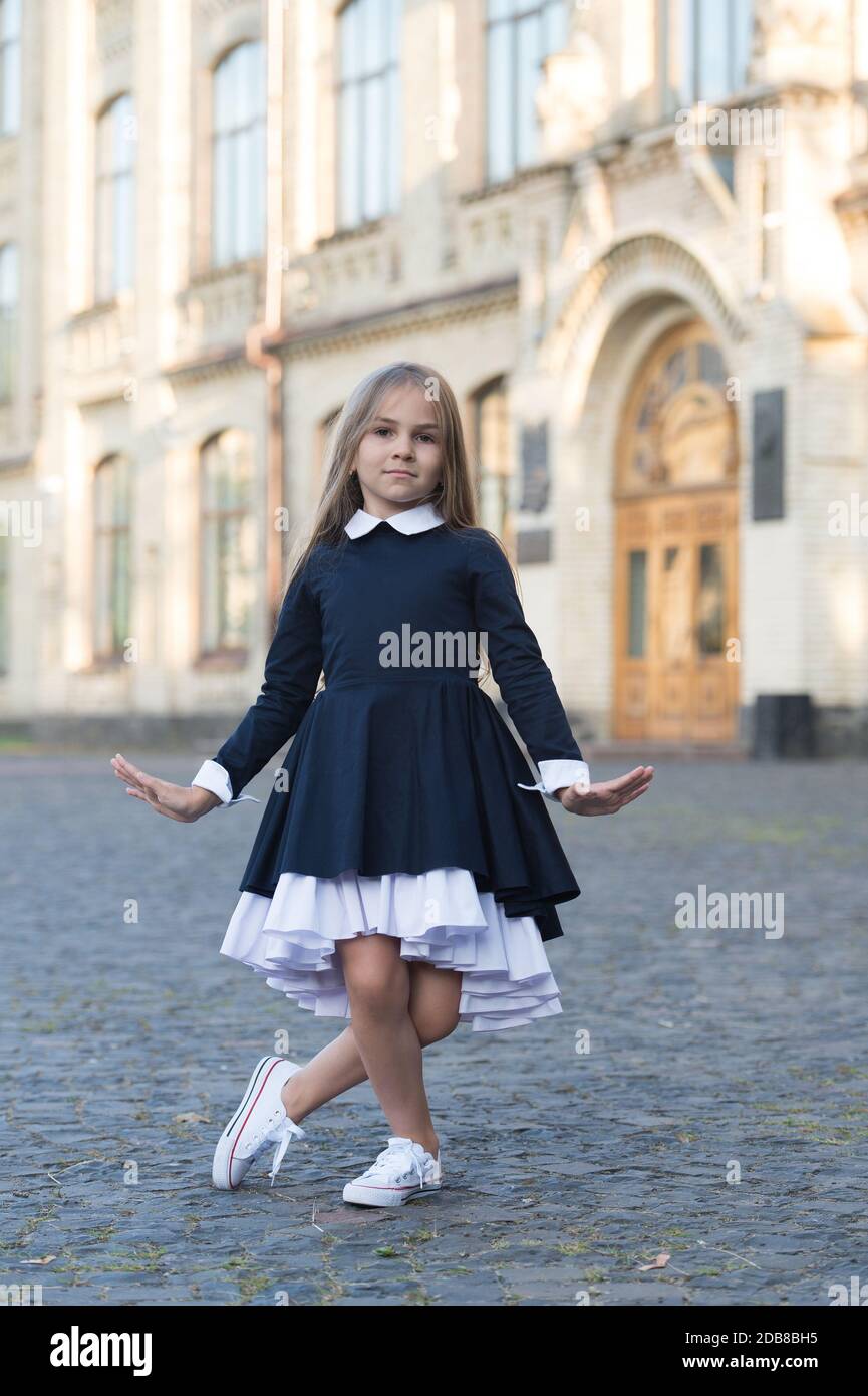 Cute little dance girl in school uniform make curtsy outdoors, dancing ...