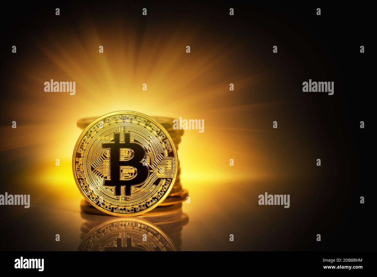 Stack and front side bitcoin in bright rays. The concept of developing ...