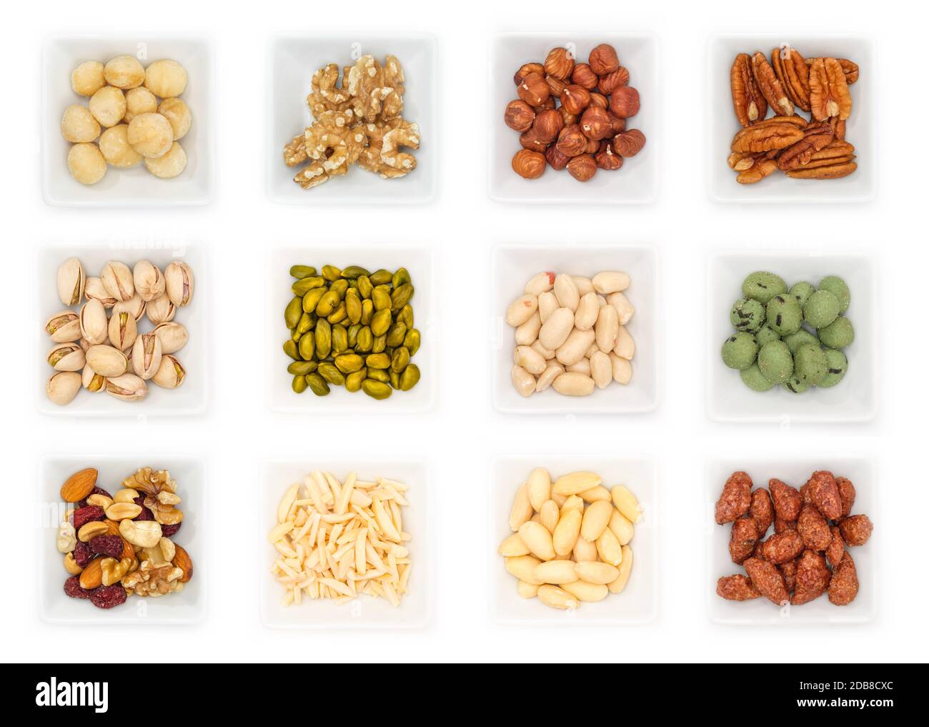 Different kind of nuts in white bowls in top view Stock Photo - Alamy