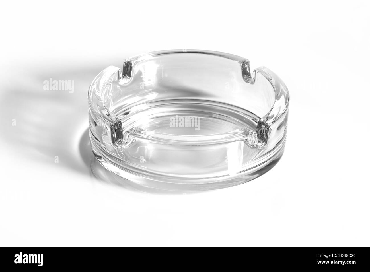 A glass ash tray on white background with shadow Stock Photo - Alamy