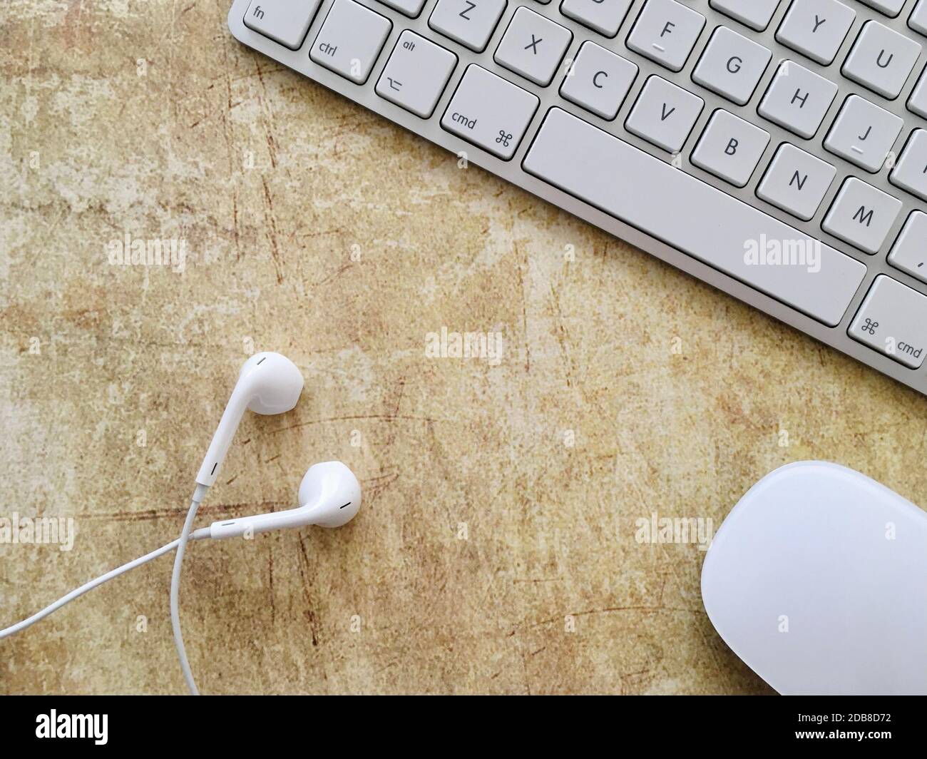 Overhead view of a computer keyboard, earphones and computer mouse ...