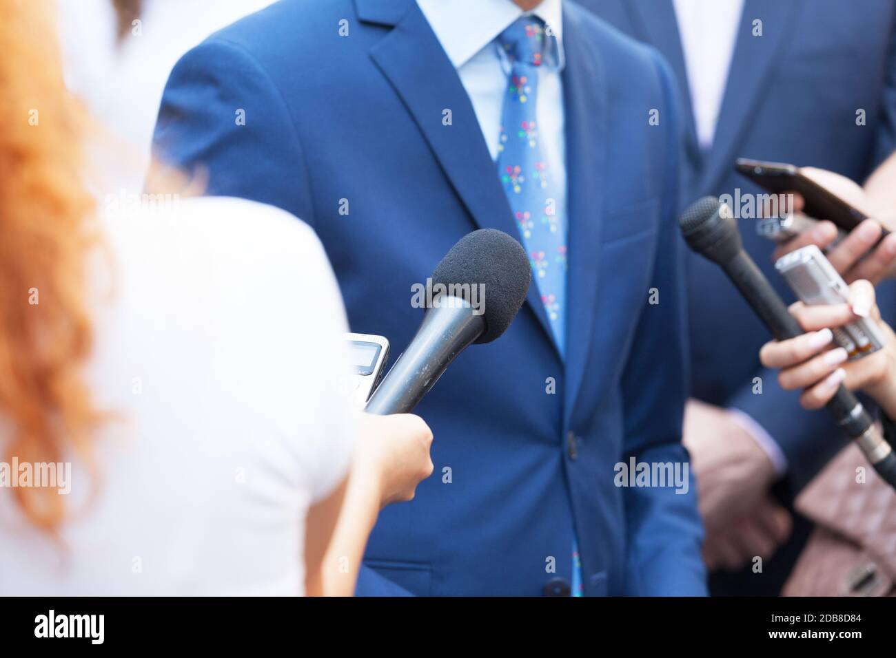 Reporters making media interview with unrecognizable businessman or ...