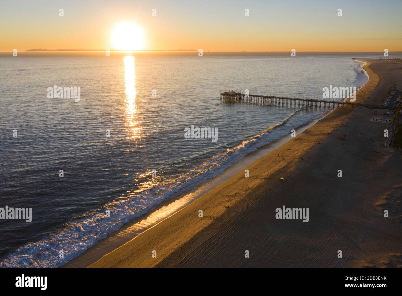 Aerial view looking up the Orange County coastline as the sun sets over ...