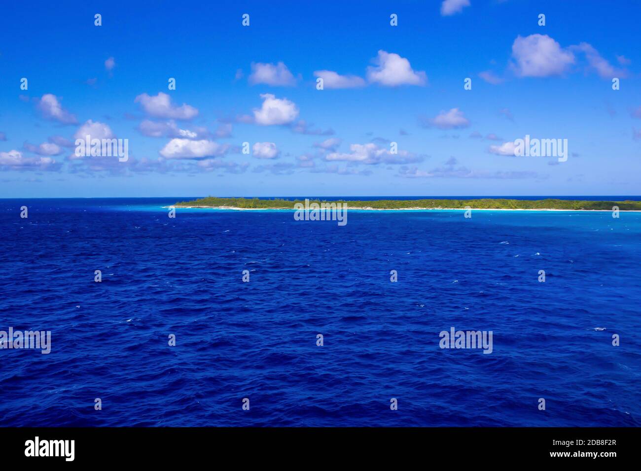 The view of beach on Half Moon Cay island at Bahamas. Blue water and ...