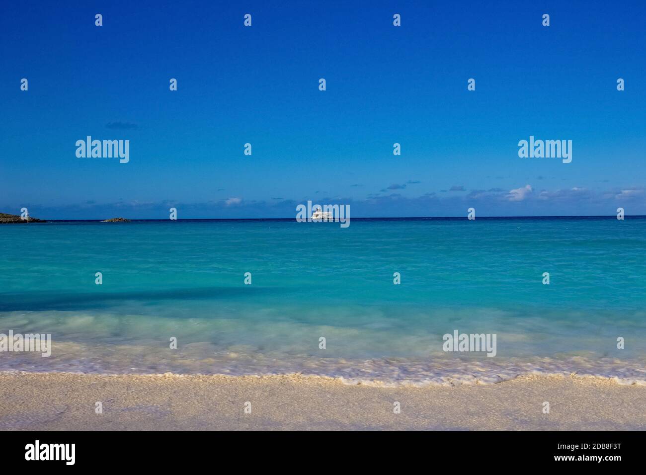 The view of beach on Half Moon Cay island at Bahamas. Blue water and ...