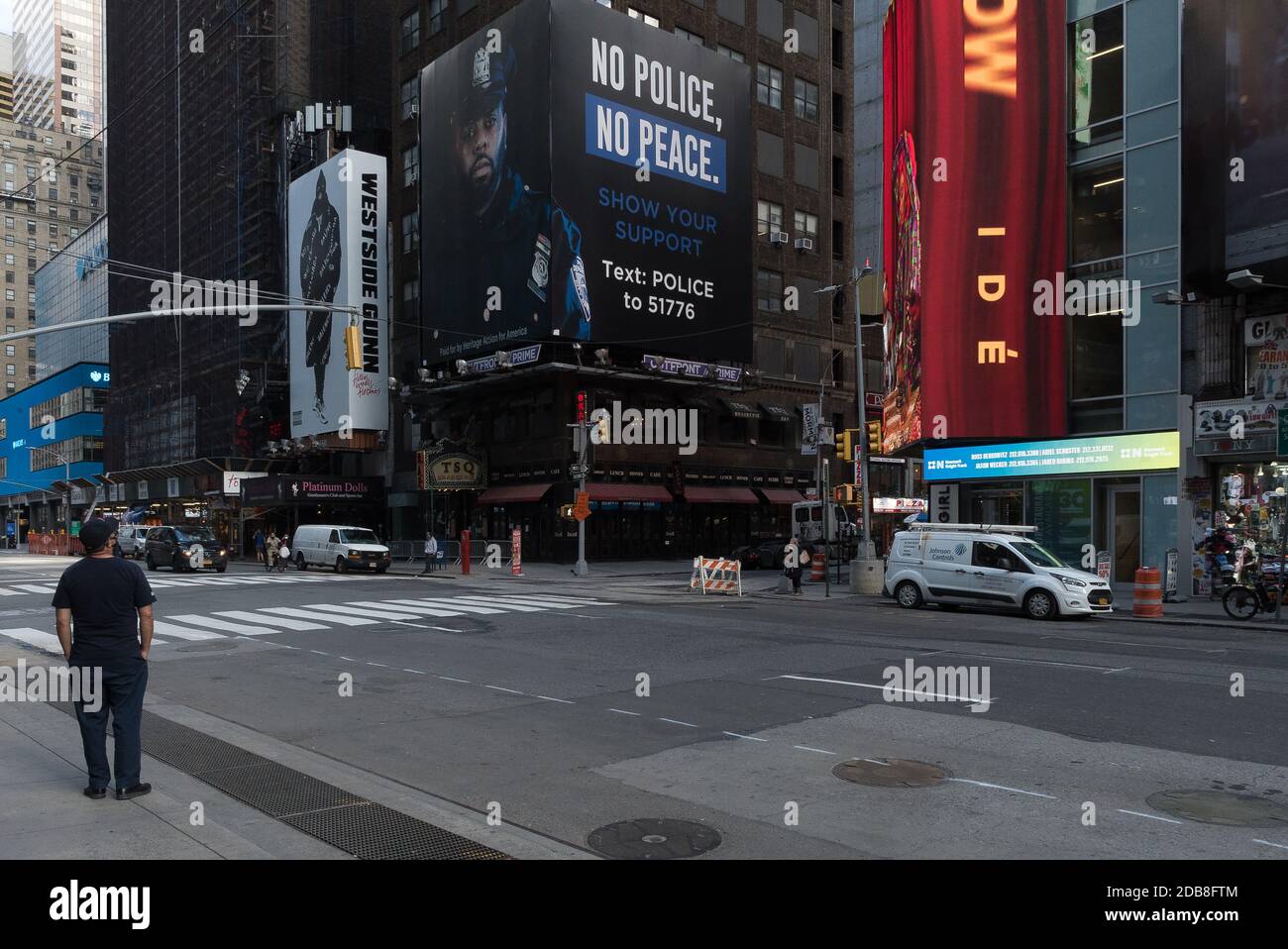 A man looks at billboard in Times square Stock Photo - Alamy