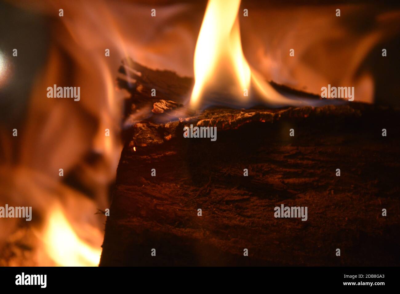 Warmth and light, a log of wood and a crackling fire in autumn Stock ...