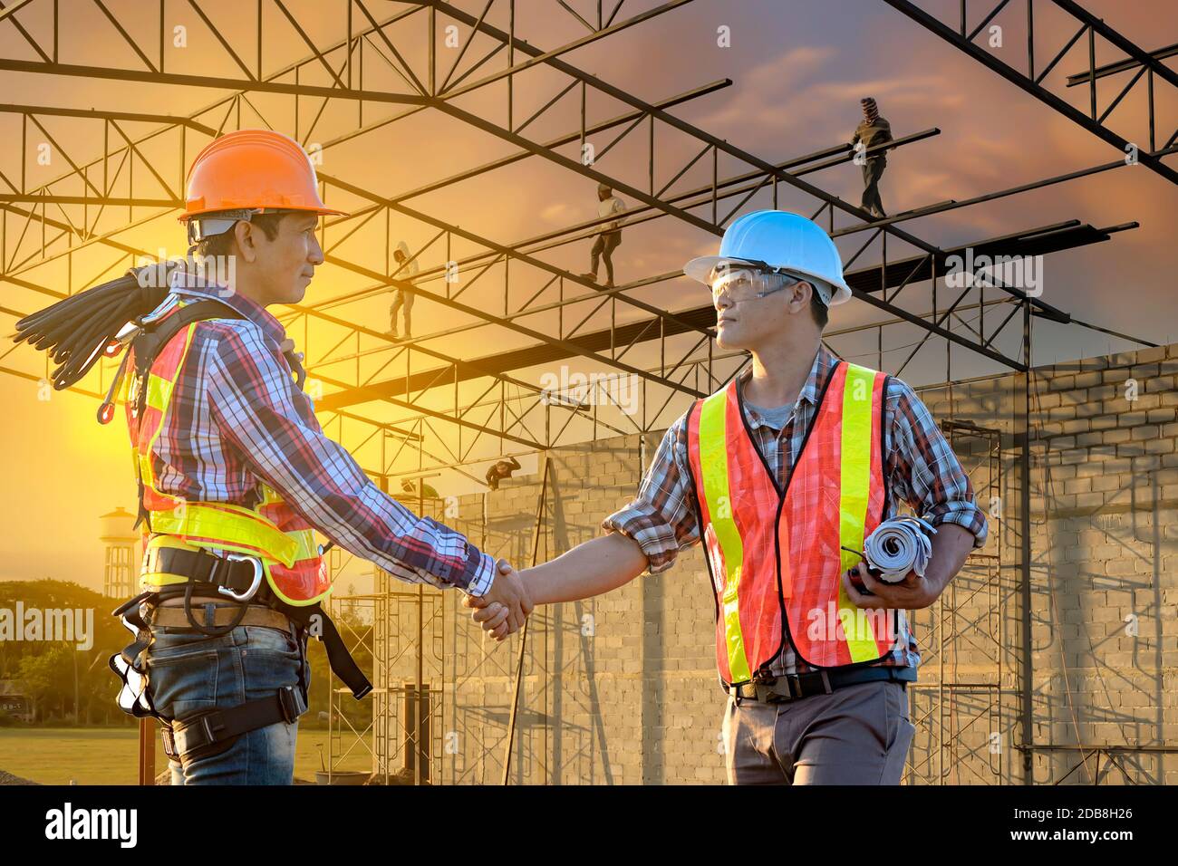 Two engineers shaking hands on a construction site, Thailand Stock ...