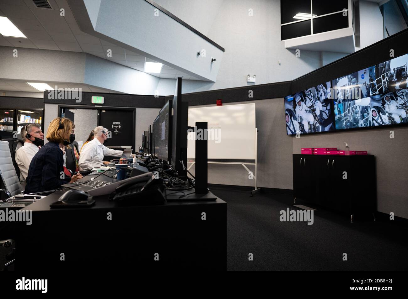 NASA managers monitor the countdown to launch of the SpaceX Falcon 9 ...