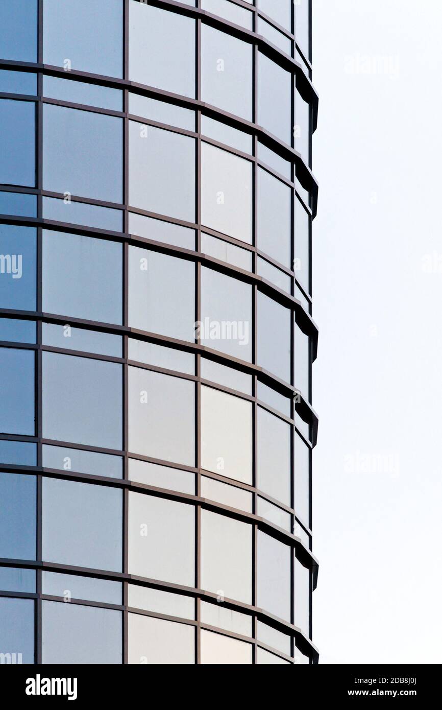 Oval business skyscraper with blue glass windows Stock Photo - Alamy