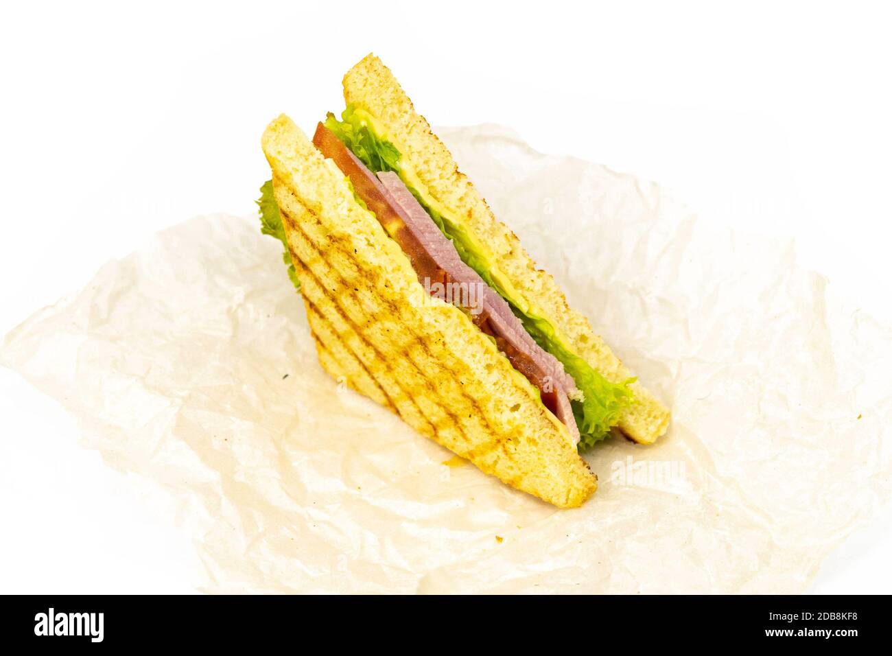 Sandwich with ham, cheese, tomatoes, lettuce, and toasted bread. Front ...