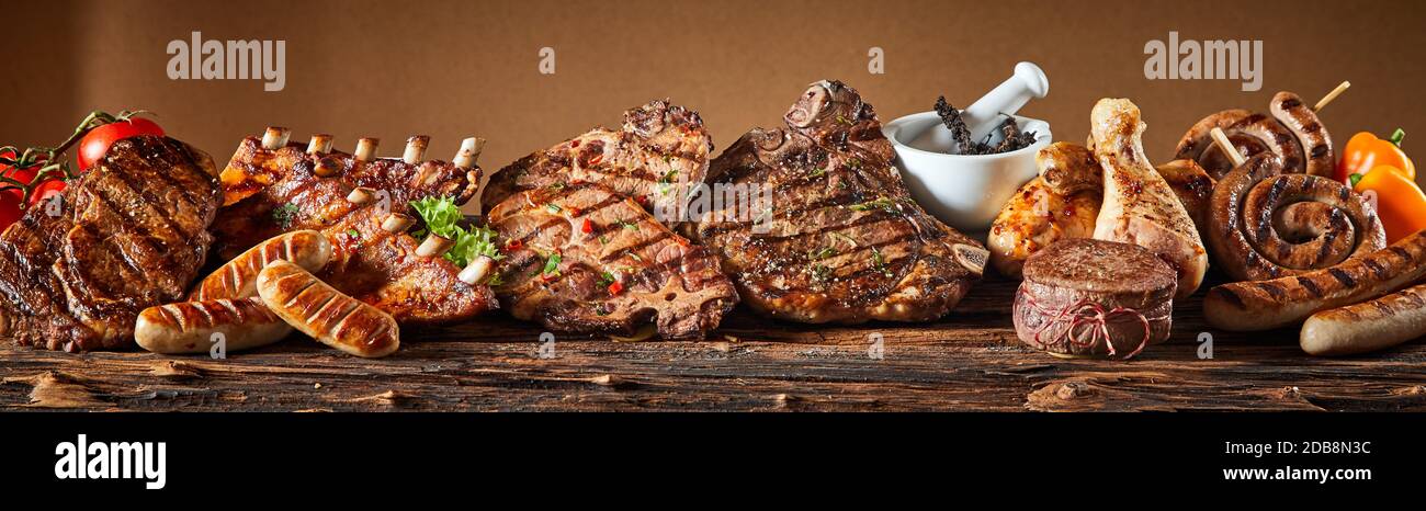 A selection of grilled gourmet meats on a rustic timber board Stock ...
