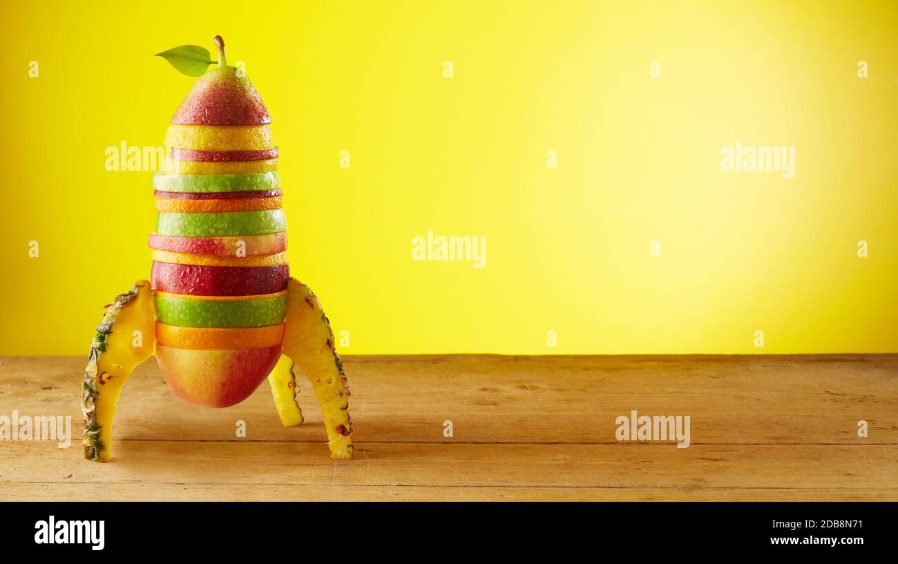 Figure of the rocket or space ship made of fresh sliced fruits ...