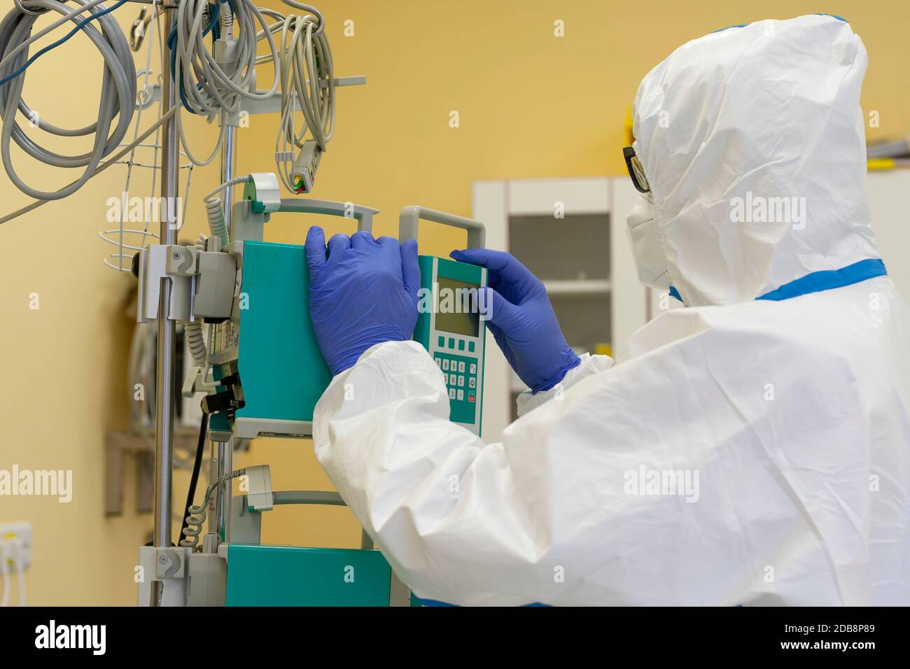 Male nurse with protective coverall clothing in intensive care unit ...