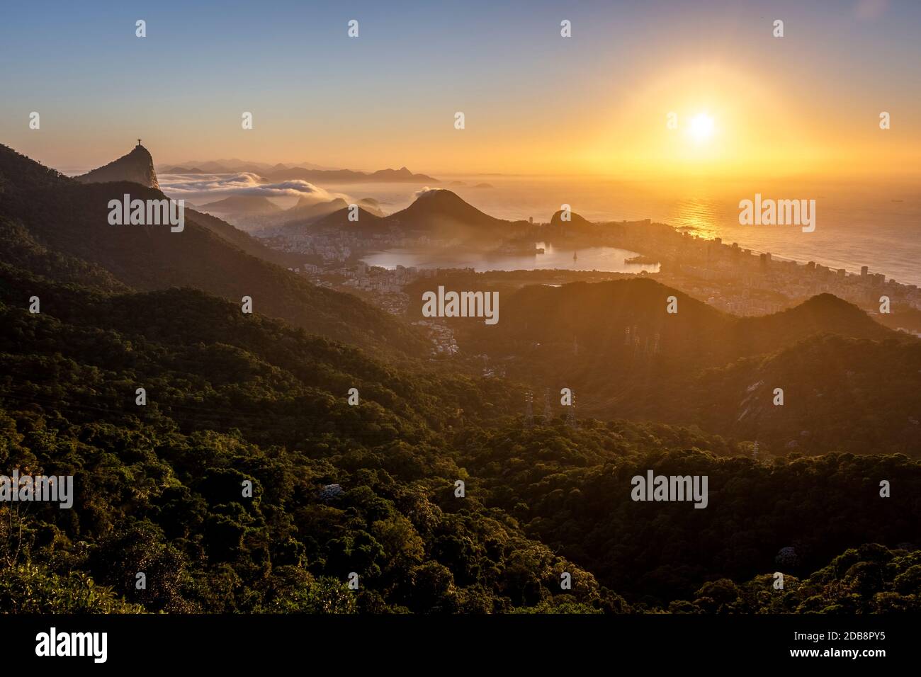 Beautiful landscape with rainforest, city and mountains by the sunrise ...