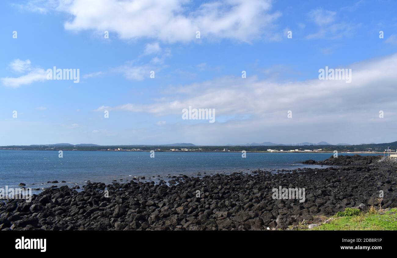Rocky beach View Blue Sky Back ground Stock Photo - Alamy