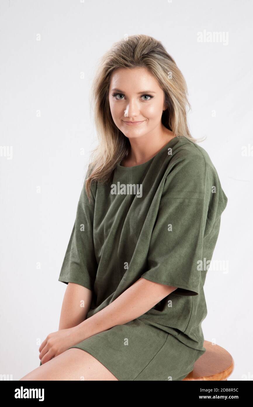 Happy woman sitting with a smile Stock Photo - Alamy