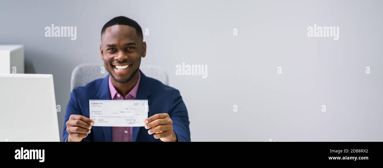 Close-up Of A Smiling Businessman Showing Company Cheque Stock Photo ...