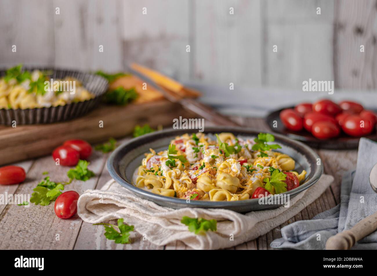Italian tortellini with herbs and cheese sauce Stock Photo - Alamy