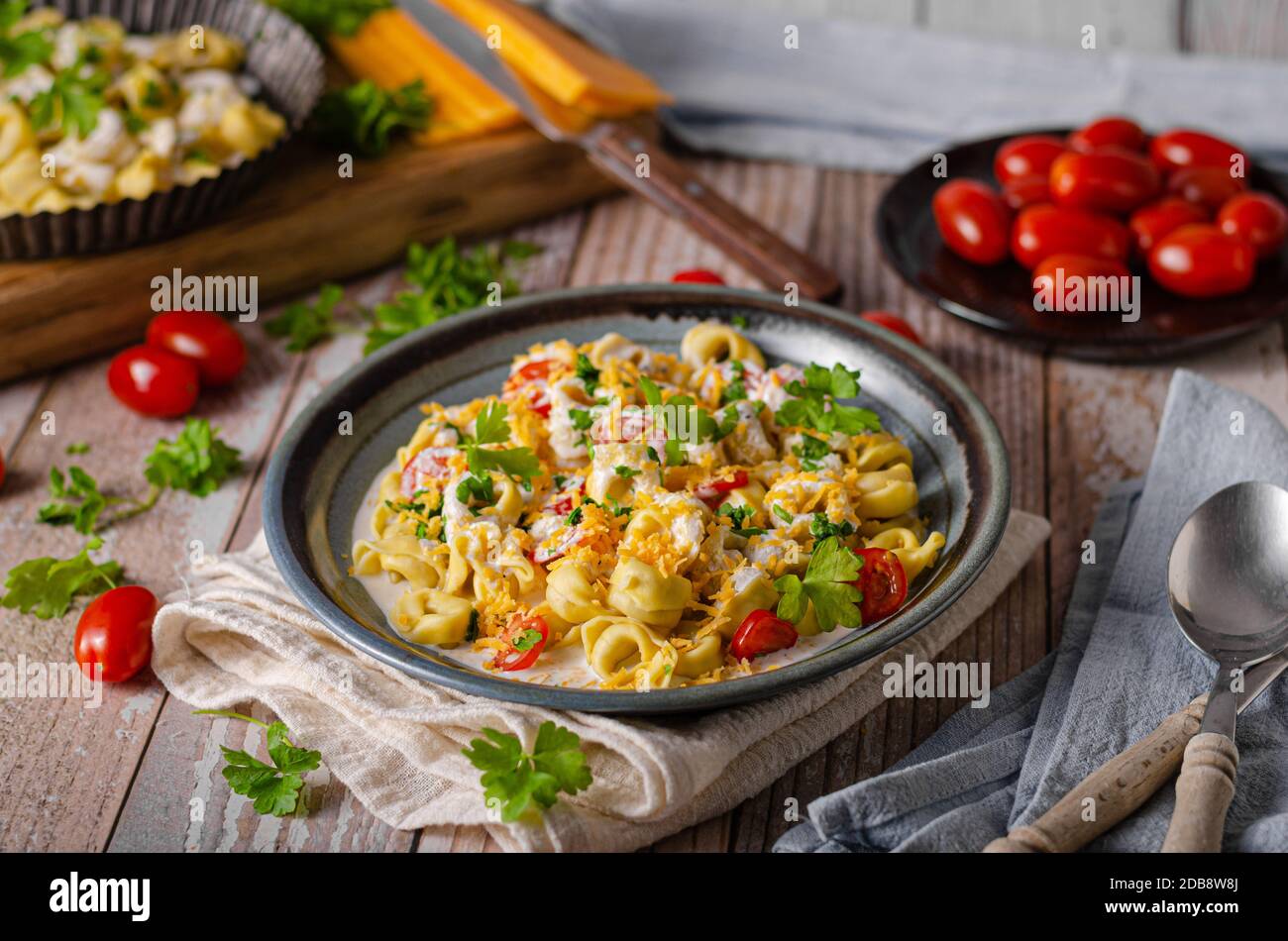Italian tortellini with herbs and cheese sauce Stock Photo - Alamy