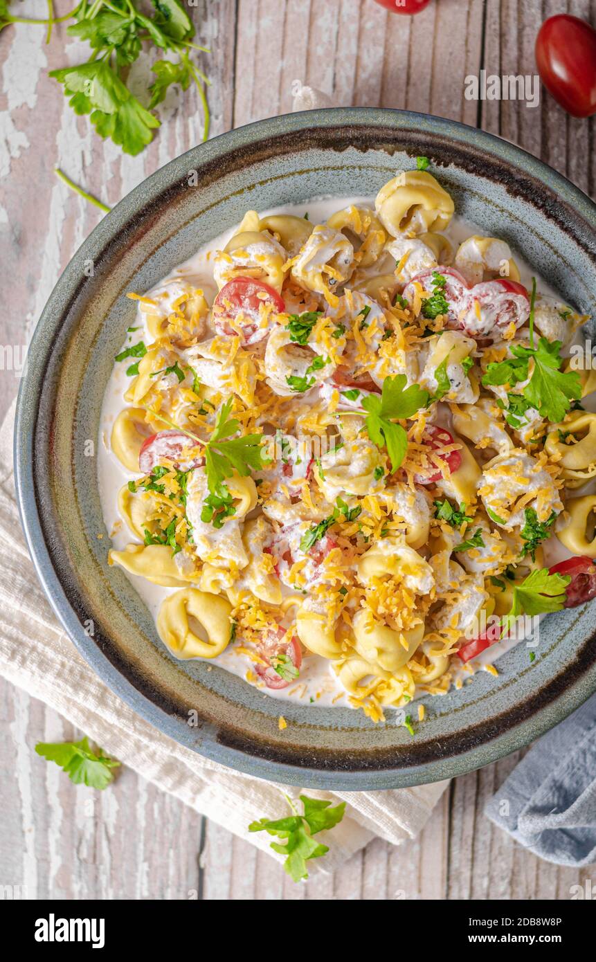 Italian tortellini with herbs and cheese sauce Stock Photo - Alamy