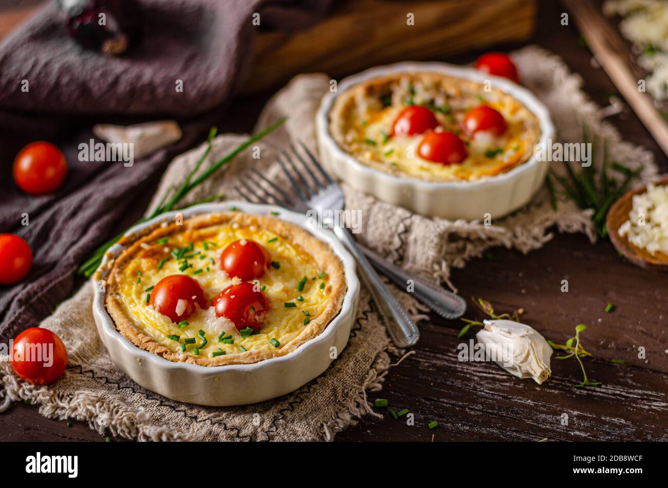 Rustic cheese quiche with bio cocktail tomatoes Stock Photo - Alamy