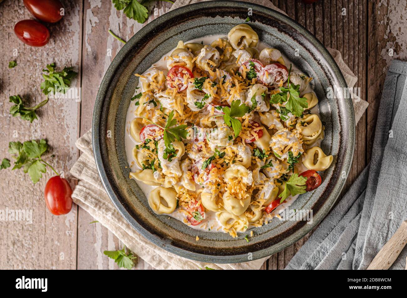 Italian tortellini with herbs and cheese sauce Stock Photo - Alamy