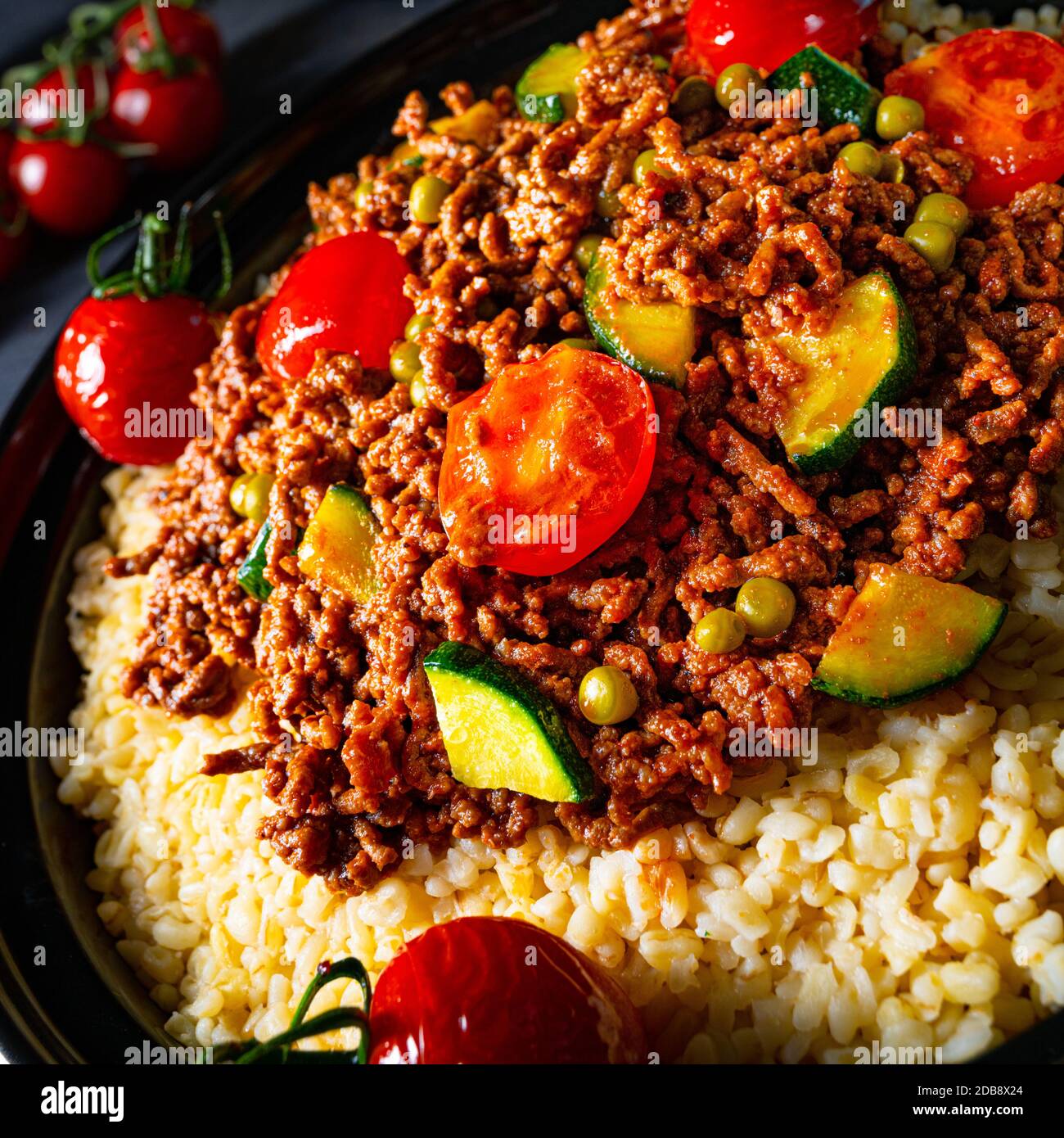Tomato bulgur with vegetables and minced meat Stock Photo - Alamy