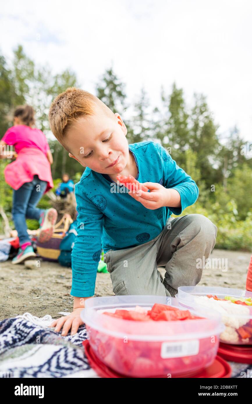 A young boy snacks on watermelon Stock Photo - Alamy