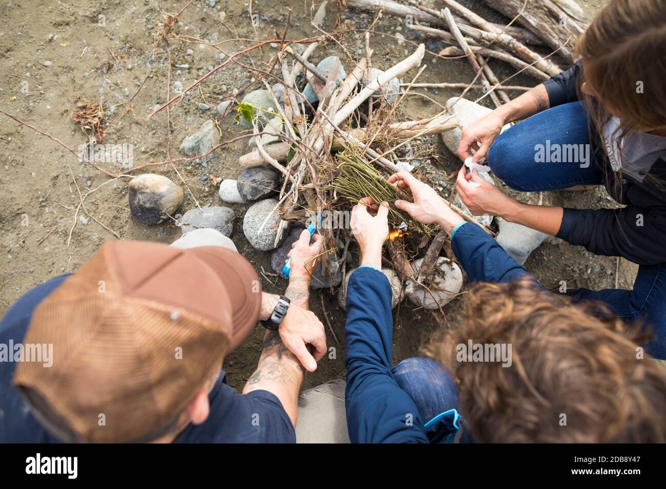 A group of people work to start a fire Stock Photo - Alamy