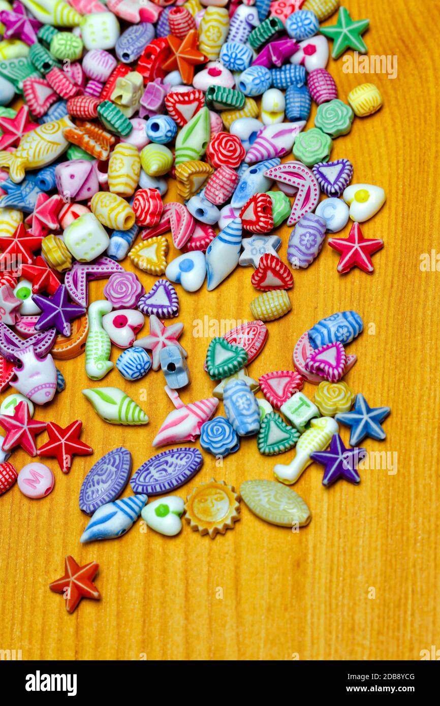 Colorful plastic craft beads pieces assortment variety Stock Photo - Alamy