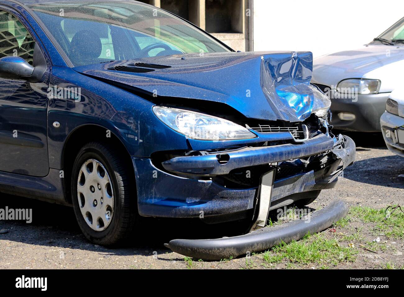 Small blue car smashed in traffic accident Stock Photo - Alamy