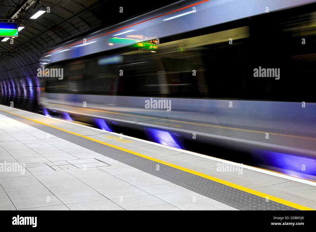 Modern speed train moving through underground station Stock Photo - Alamy