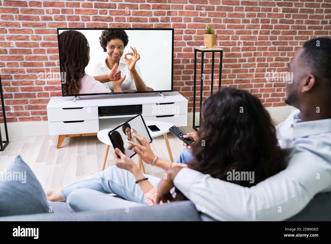 Couple Streaming Movie From Tablet To TV Using Wireless Connection ...