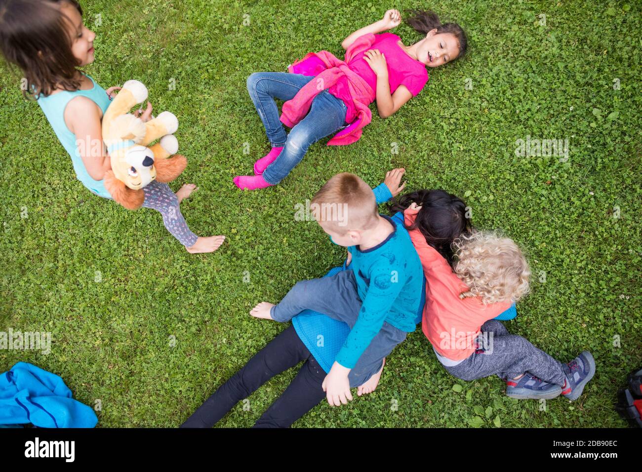 Kids playing / dogpiling on the grass Stock Photo - Alamy
