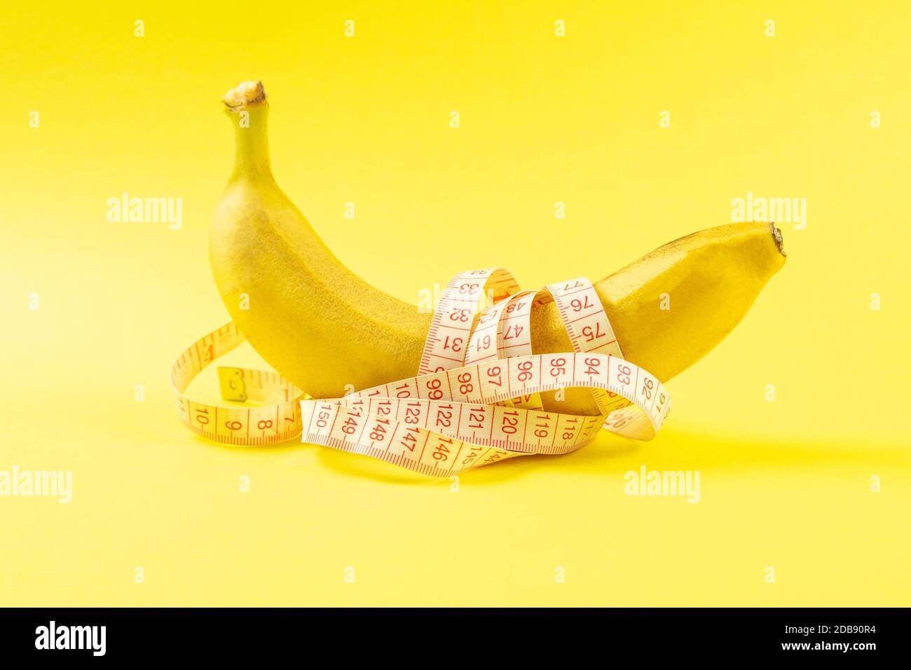 Banana with tape for measuring figure. Centimeter ruler spinned around ...